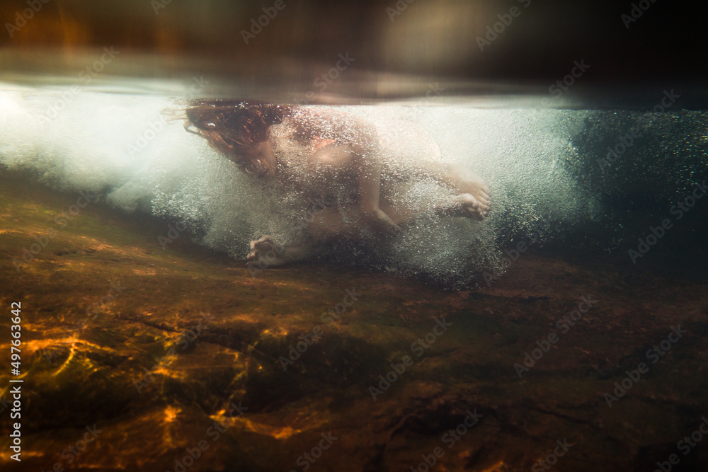 Underwater woman flowing with river stream Stock Photo | Adobe Stock