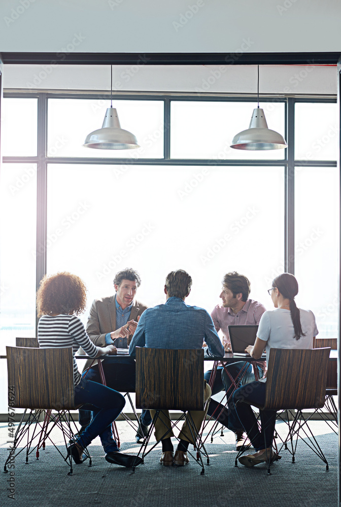The round table of great ideas. Shot of a group of coworkers having a ...