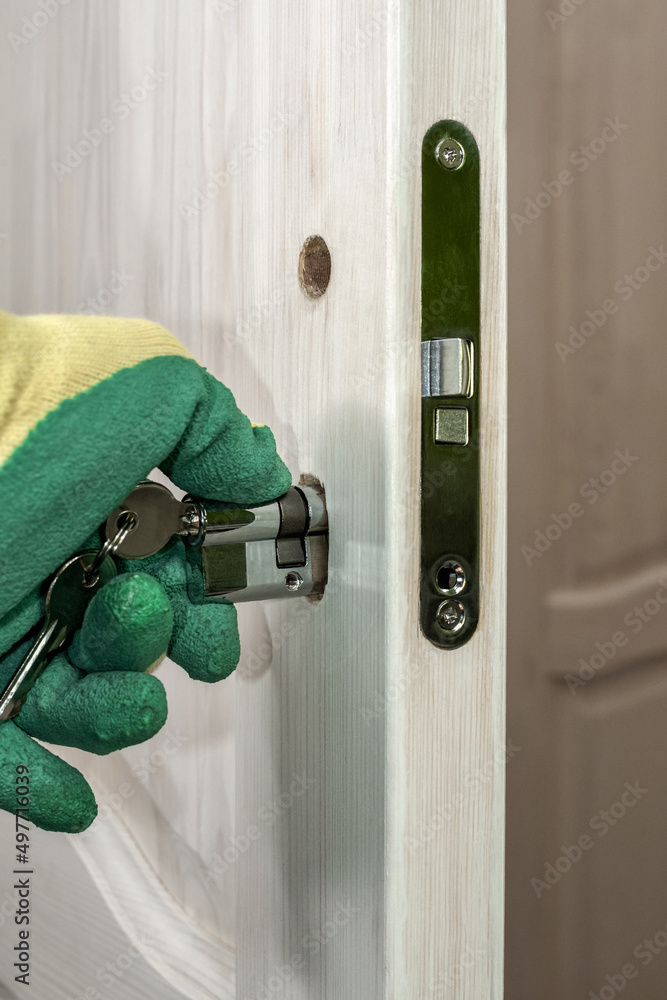 Door lock repair and cylinder replacement. Installation and insertion ...