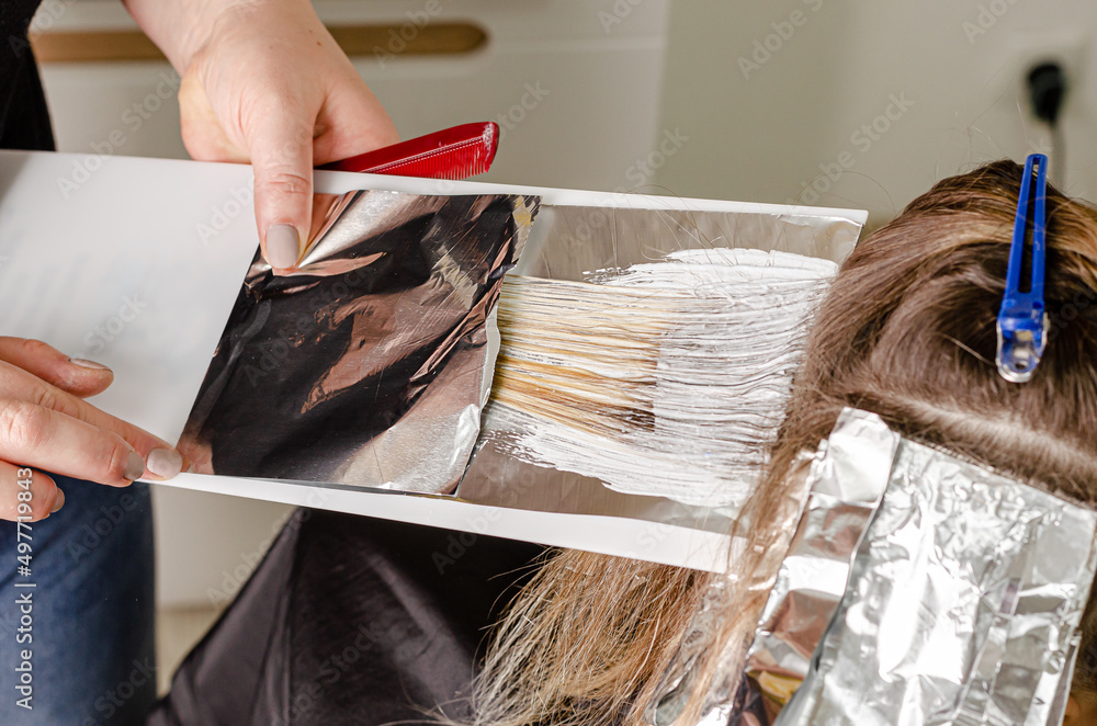 Process of applying bleaching powder on clients hair and wrapping into ...