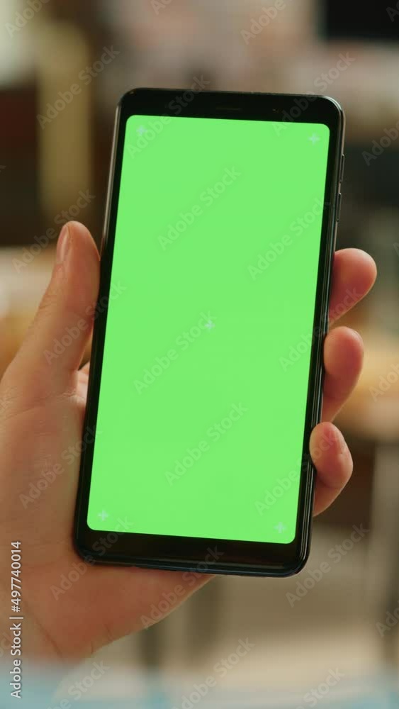 Vertical Screen: Hand Scrolling Feed on Smartphone with Green Screen Mock Up Display. Person ...