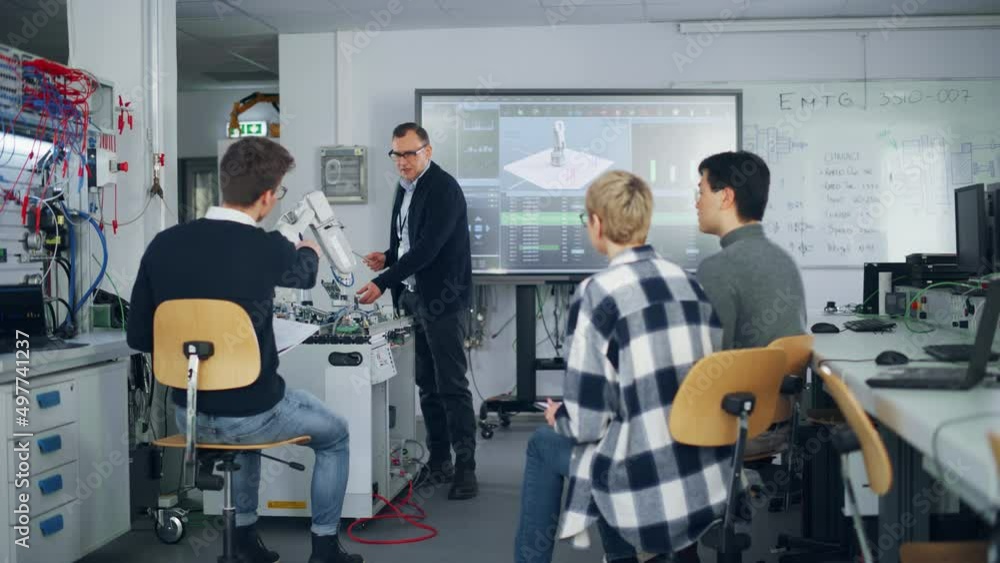 Male Teacher Showing Details of Robot Arm and Brainstorming with ...