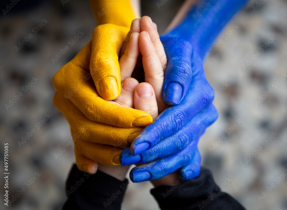 female hands painted in yellow and blue colors of Ukrainian flag hold ...