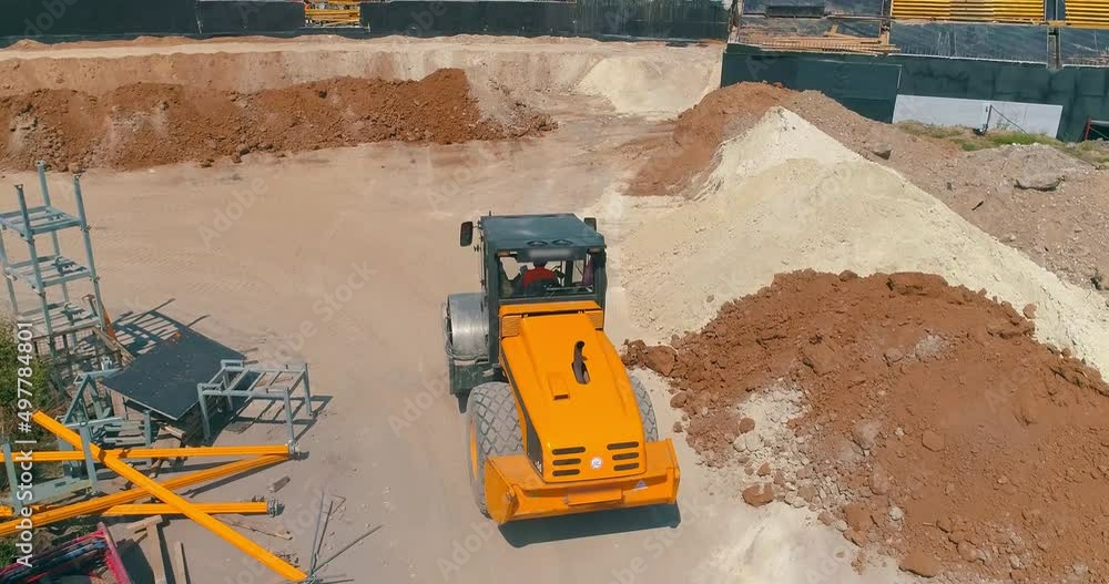 Soil Compactor aligns earth on a construction site. Soil Compactor ...