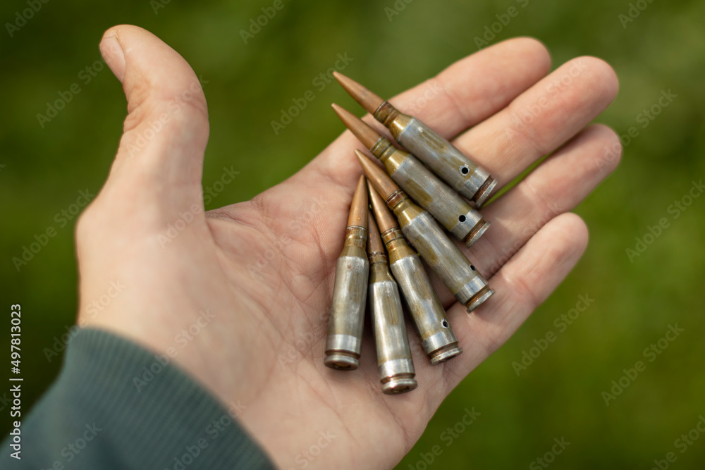 Cartridges in the palm of your hand. Machine gun bullets in the hand ...
