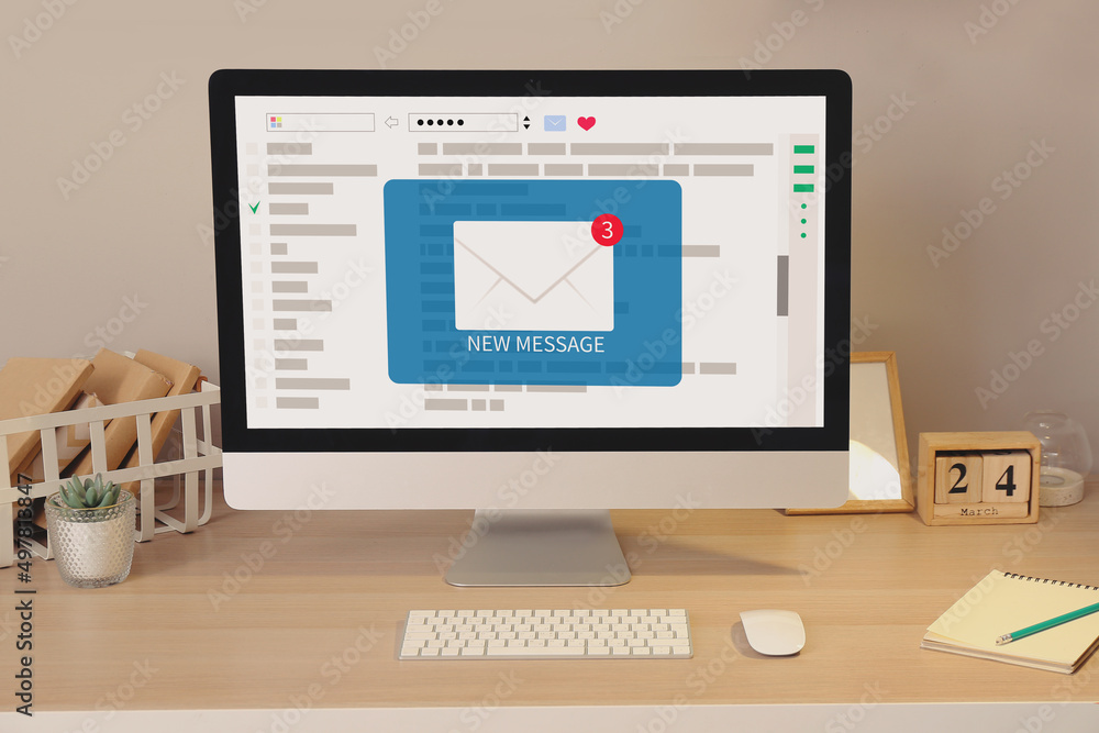 Computer with symbol of new unread e-mail messages on screen at ...