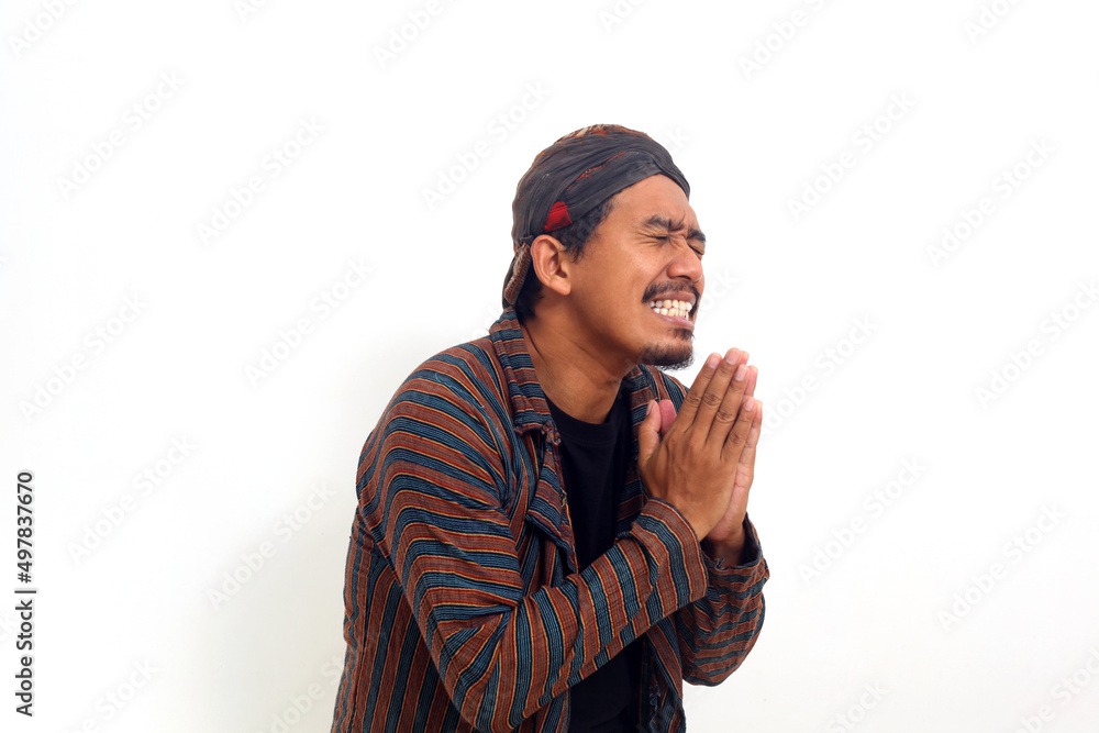 Sad asian man in java traditional costume begging for forgiveness ...