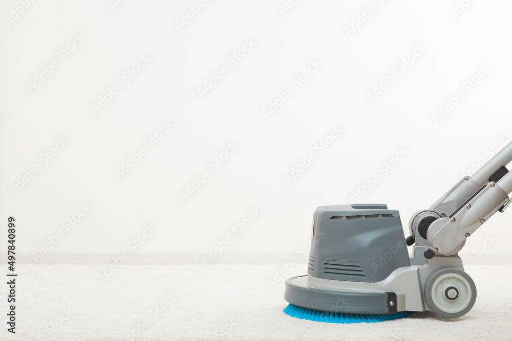 Gray professional disc machine on white carpet. Closeup. Foaming and ...
