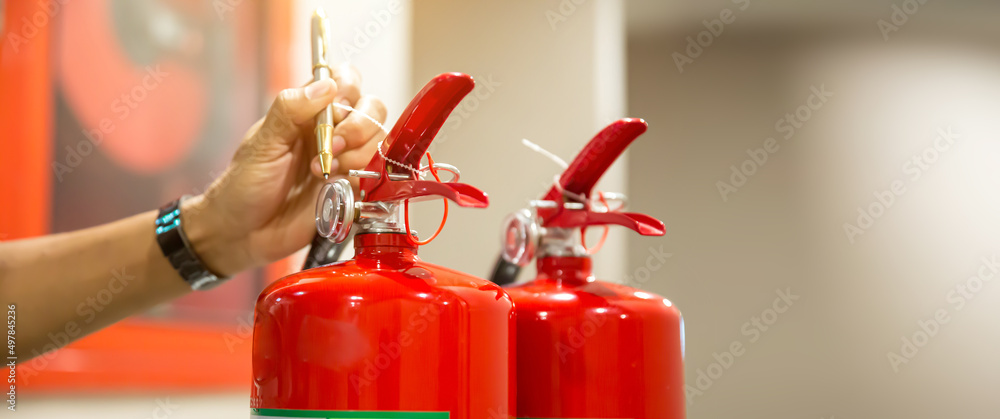 Fire extinguisher has hand engineer inspection checking pressure gauges ...