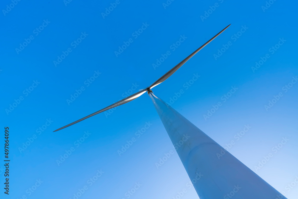 Giant Wind Turbine Seen From Below With Blue Sky Background This Is A