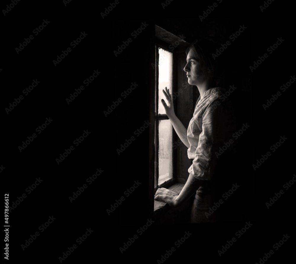 Woman praying at the window Stock-Foto | Adobe Stock