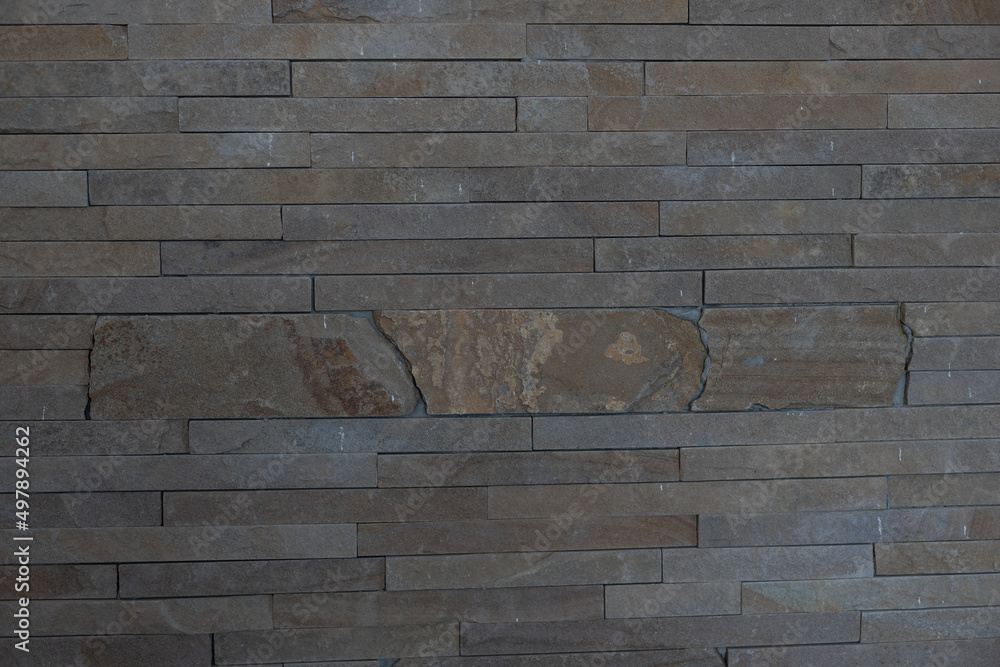 Elegant stone cladding wall made of gray granite with different shades ...