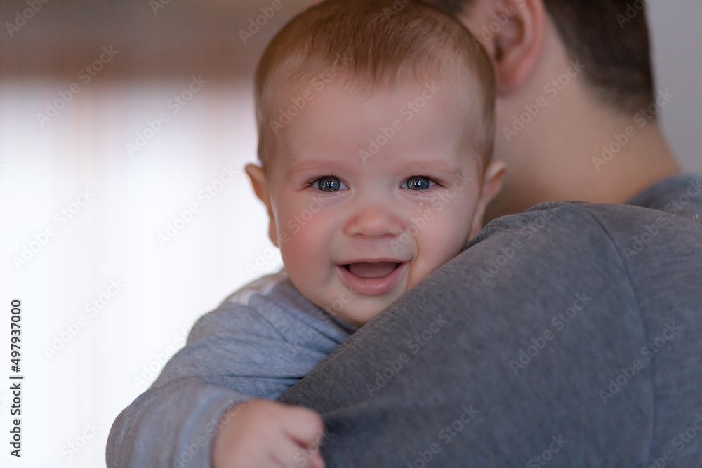 The little boy is crying and smiling. Crisis of one year in a child ...