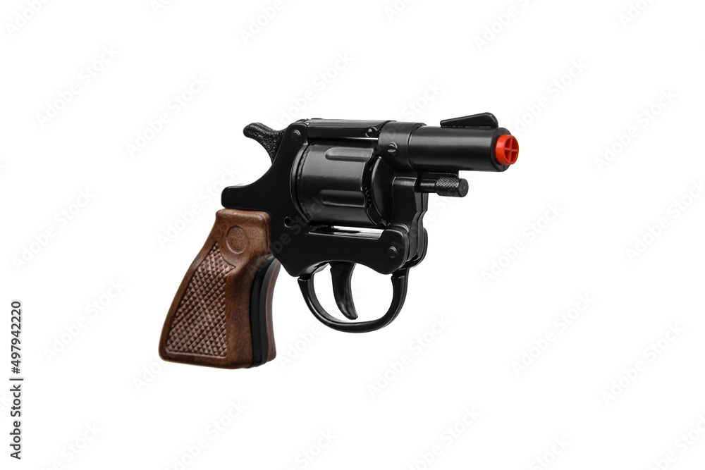 Toy gun revolver. Black pistol with brown handle. Isolate on white back ...