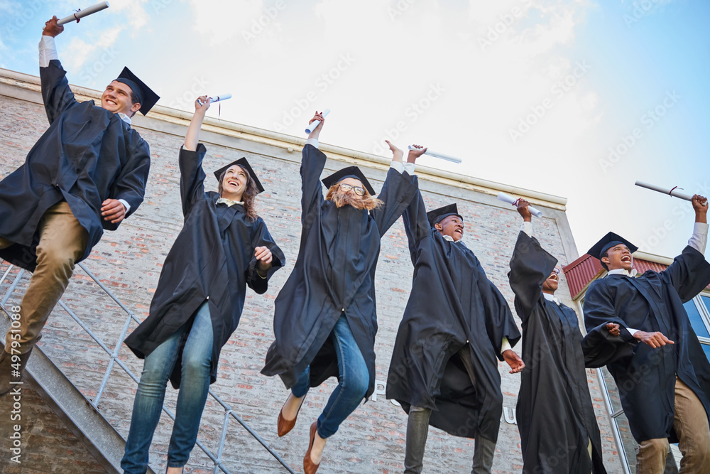 Graduation is a cause for celebration. Low angle shot of a happy group ...