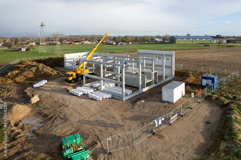 the basic structure of an industrial building is erected on a ...