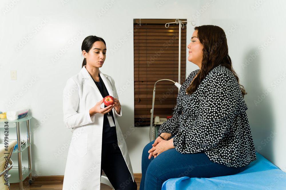 Beautiful female doctor and obese woman Stock Photo | Adobe Stock