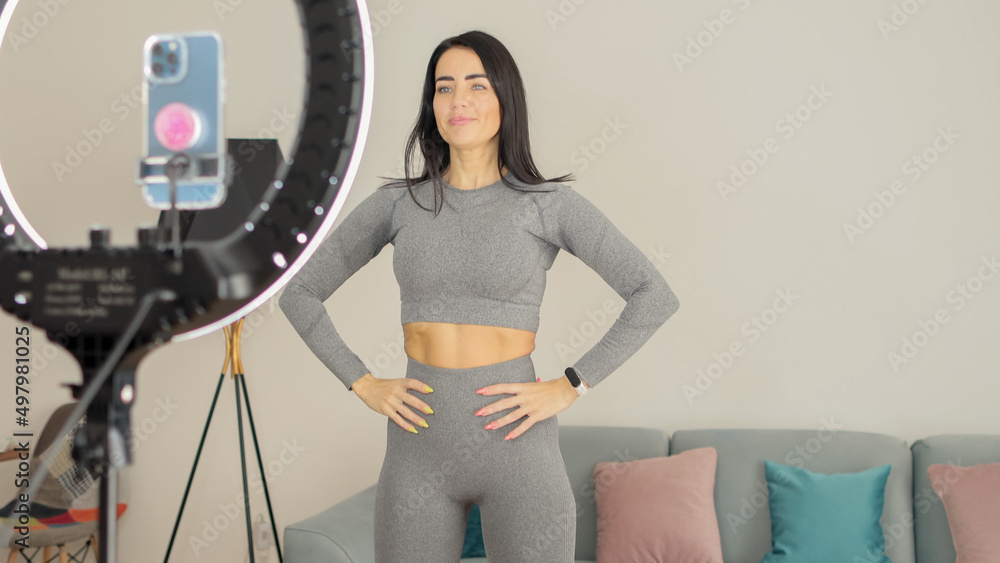 Virtual online fitness. Woman virtual workout at home living room ...