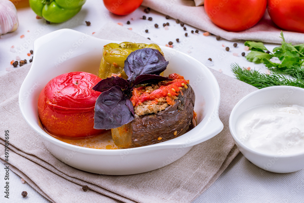 dolma in azerbaijani, meat in grilled vegetables on a white plate Stock ...