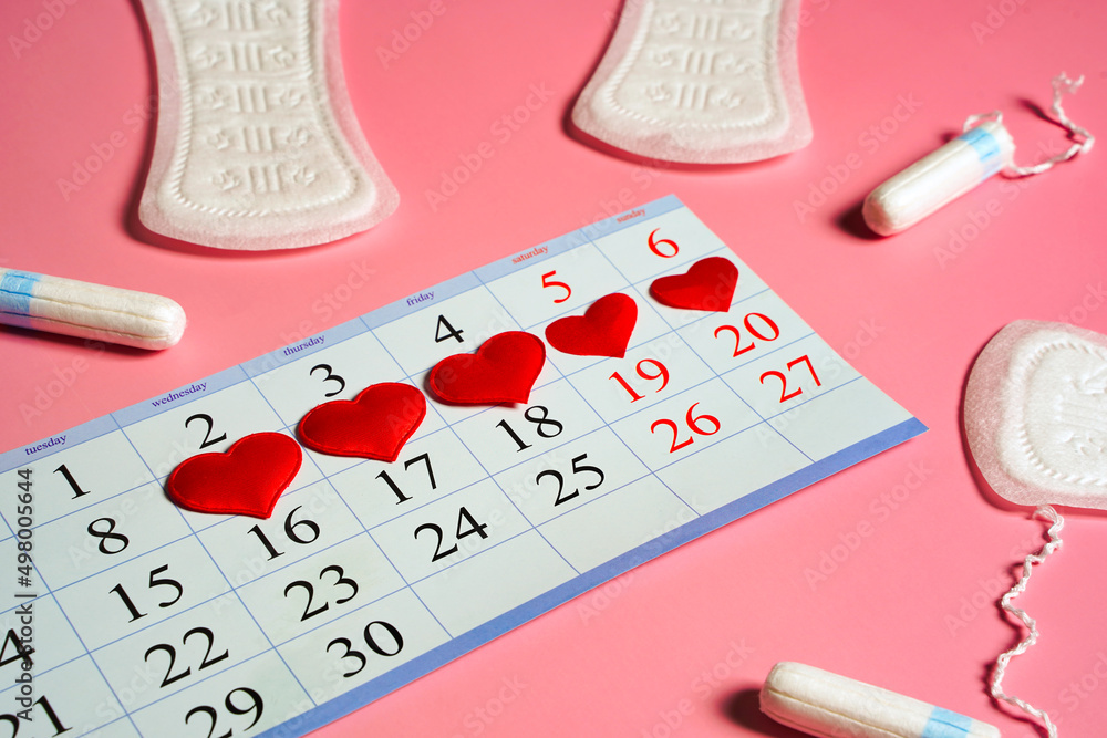Menstruation days products, red heart and calendar with red marked ...