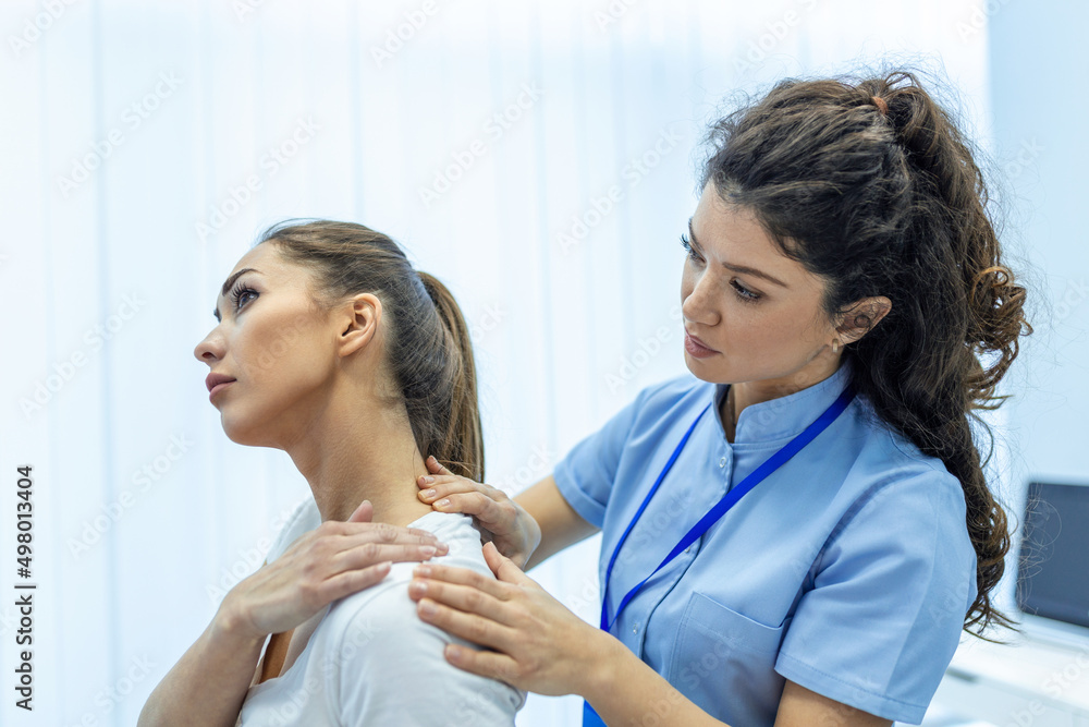 Woman Doctor Osteopath In Medical Uniform Fixing Woman Patients