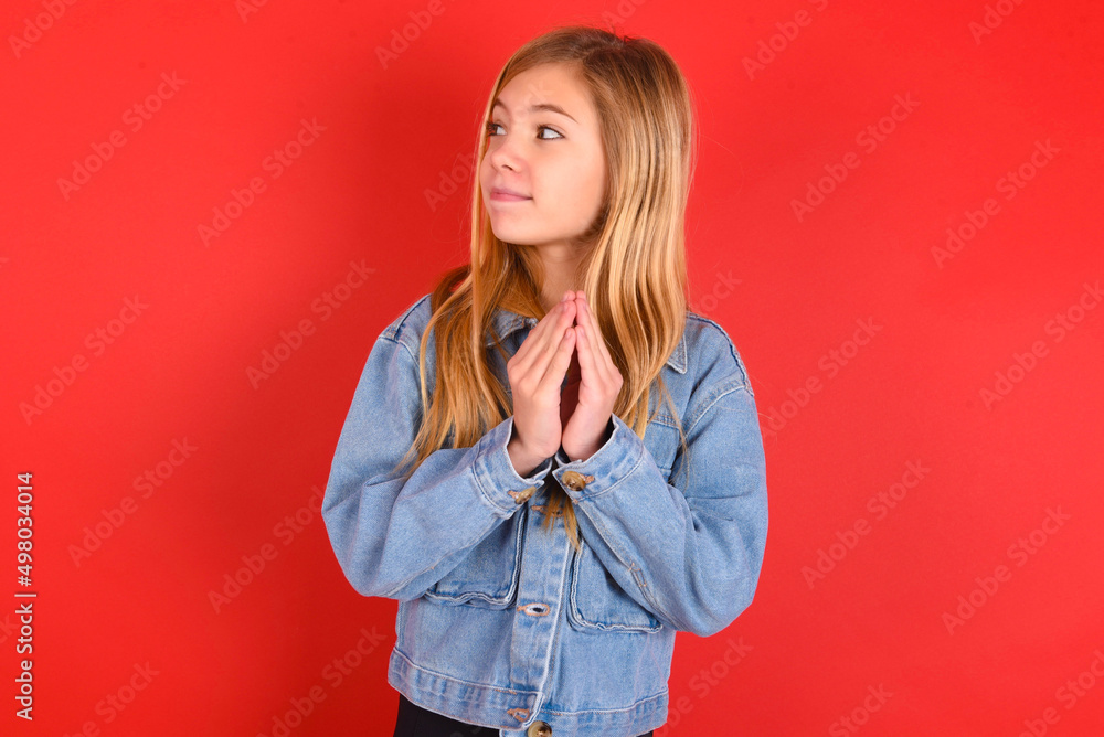 Charming cheerful blonde little kid girl wearing denim jacket over red ...