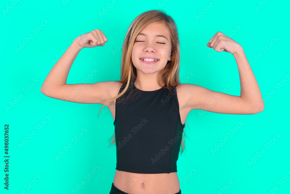 Strong powerful blonde little kid girl wearing black sport clothes over ...