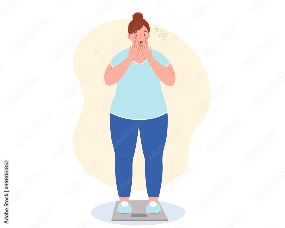 Obese woman stands on the scales, shocked by the weight gain. She upset ...
