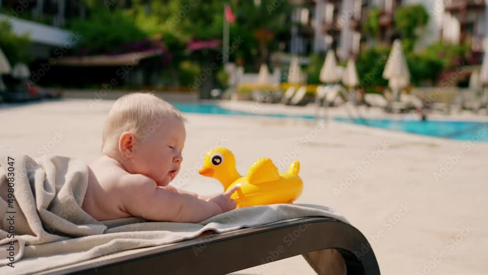 Cute baby having family rest on beach spa resort with yellow rubber ...