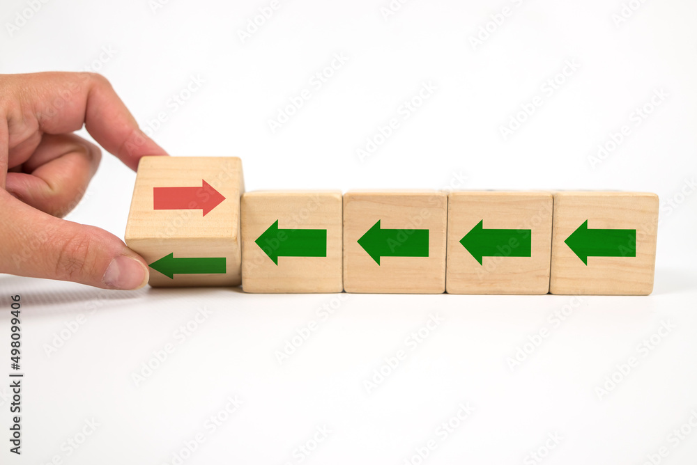 Hand flip over wooden cube block with red arrow facing the opposite ...