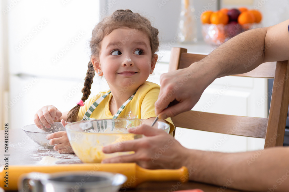happy child help to father in kitchen. kid cooking food with dad ...