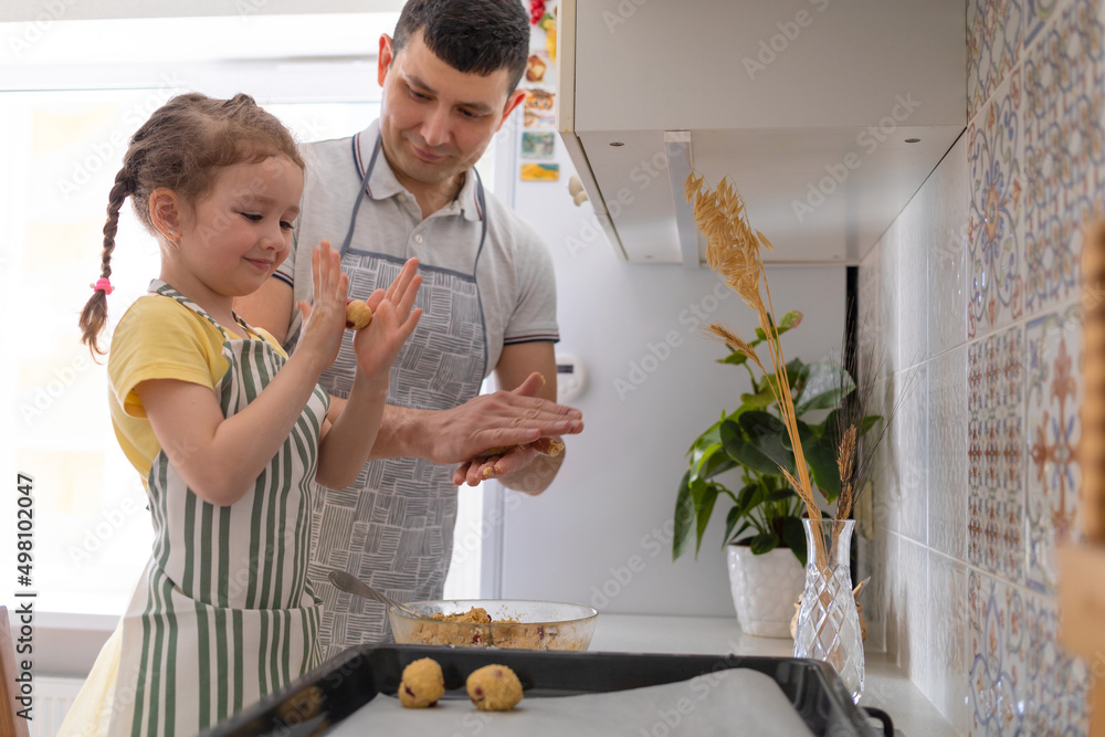 child help to father in kitchen. kid cooking food with dad. little girl ...