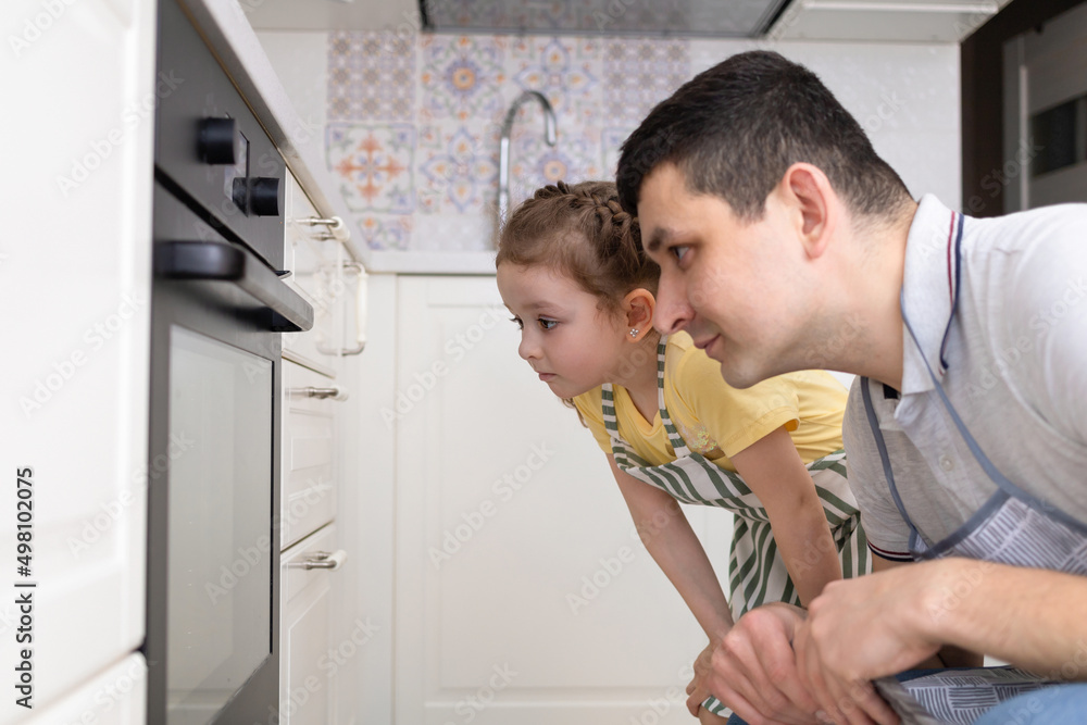 Father, doughter in apron preparing food in kitchen. cute child, man ...