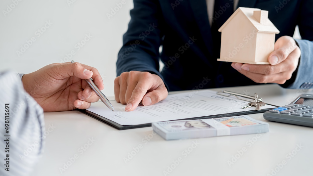 Real estate agent and customer signing contract to buy house, insurance ...