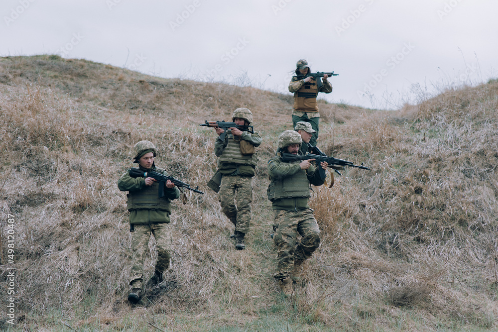 Team of five Ukrainian soldiers aims from kalashnikov assault rifles to ...