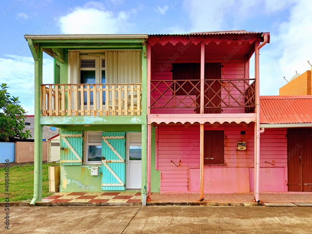 Typical rural Caribbean style houses with pink and green colored walls ...