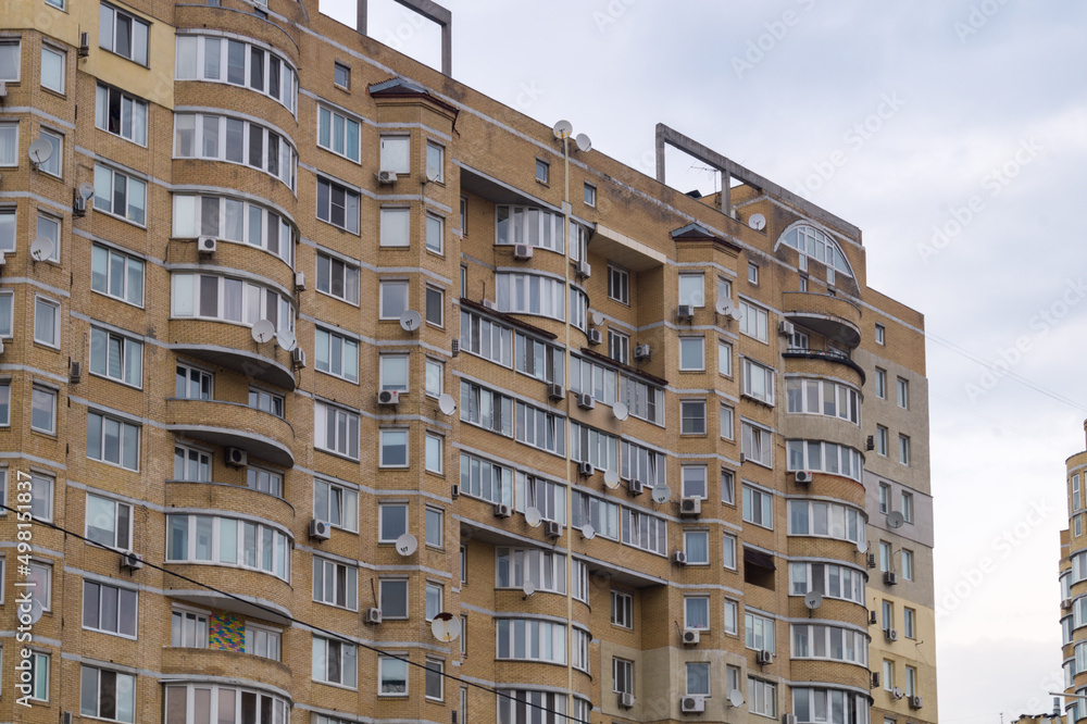 Residential high-rise building made of bricks. Wall with a lot of ...