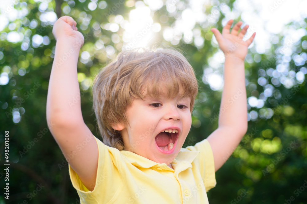 Excited kids. Portrait of adorable little boy on green background park ...
