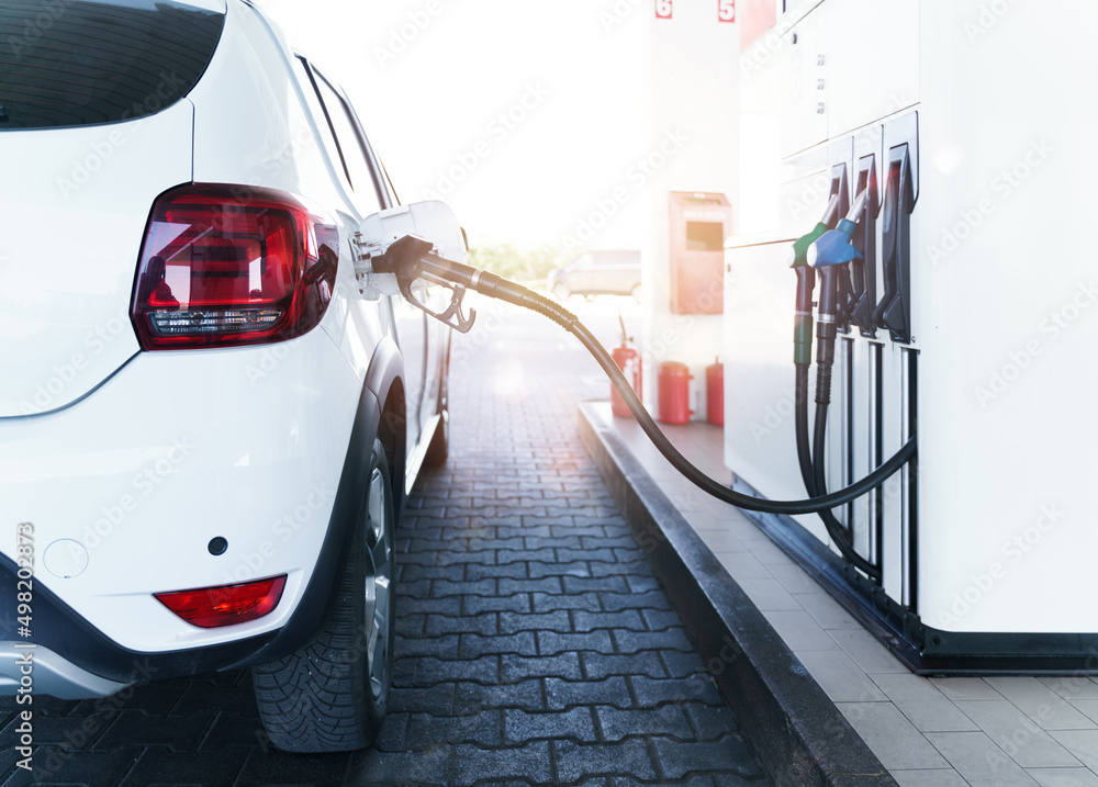 Fuel pump fill a tank of a car in a station Stock Photo | Adobe Stock