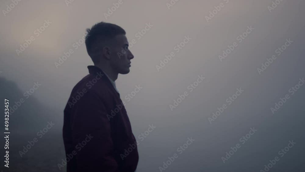 Upset guy walking on sea beach at sunrise. Exhausted man screaming ...