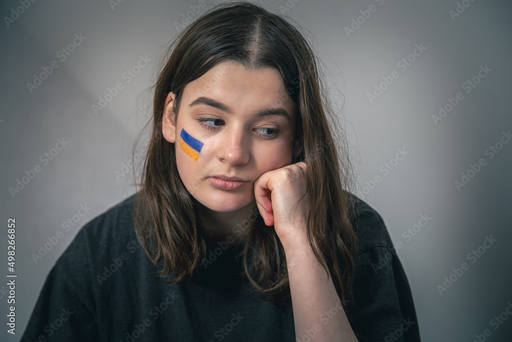 A Ukrainian girl with a painted flag of Ukraine on her face. Stock ...
