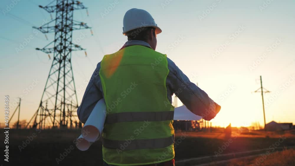 Worker male engineer using documents for checking data while standing ...