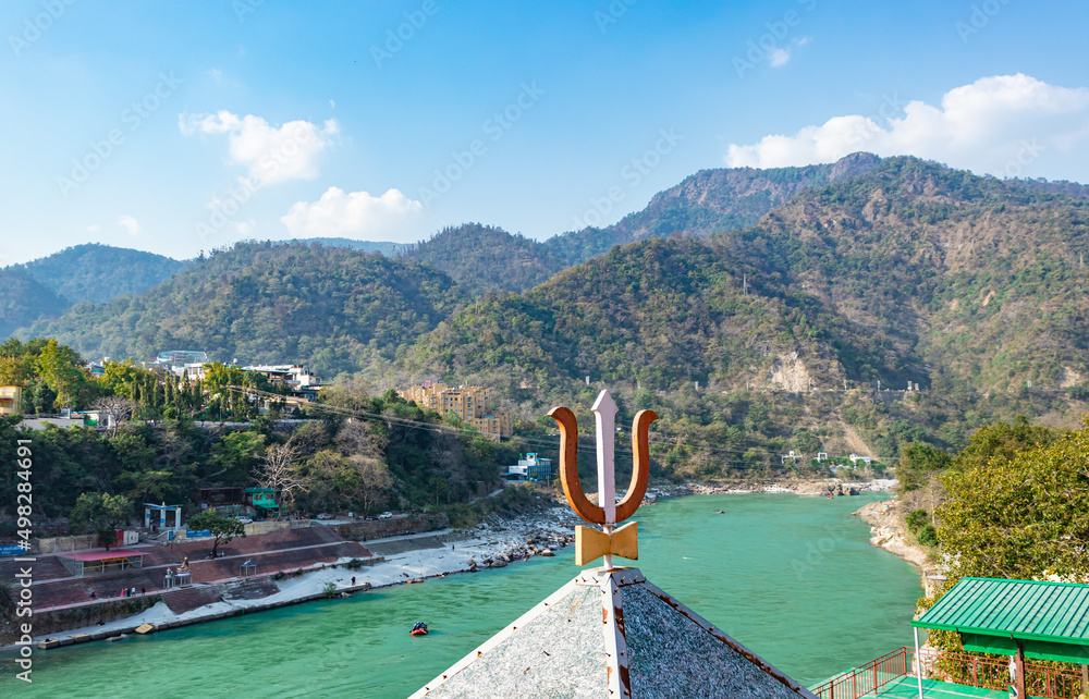 indian religious symbol trishul with mountain and blue sky background ...