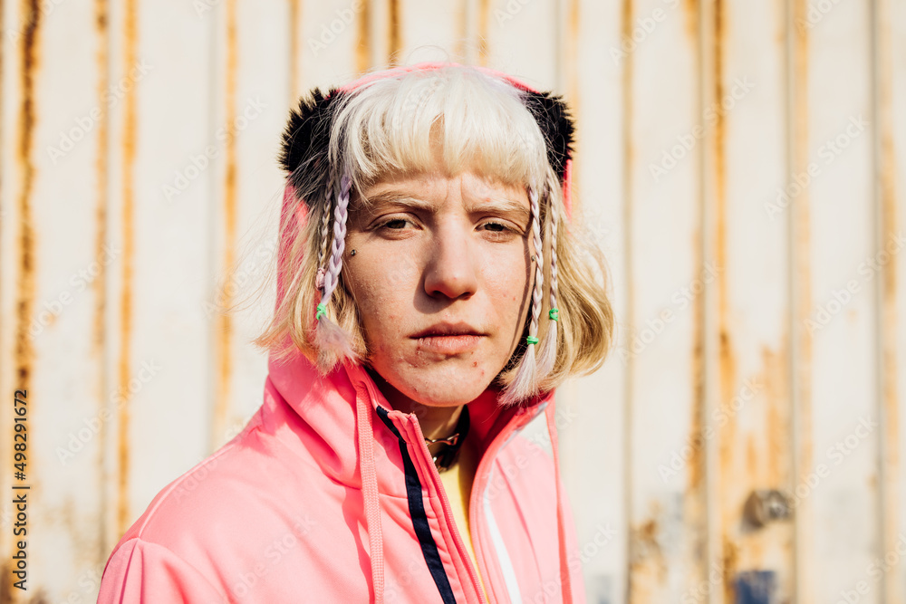 Diverse non binary woman no makeup posing outdoor looking camera ...