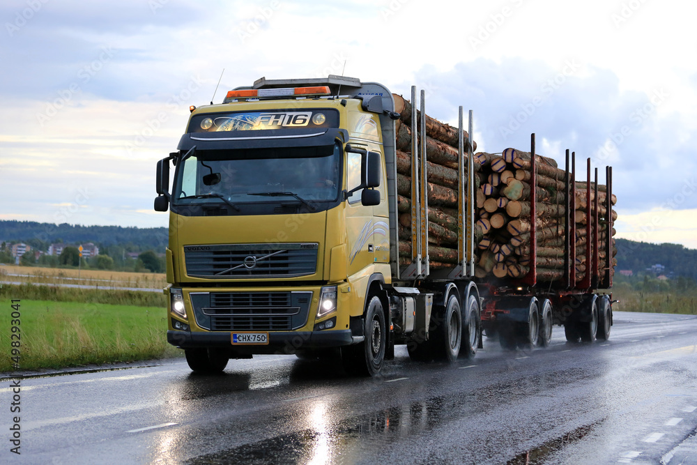 Volvo FH Logging Truck on Hauls Load along Wet Road on a Rainy Day ...