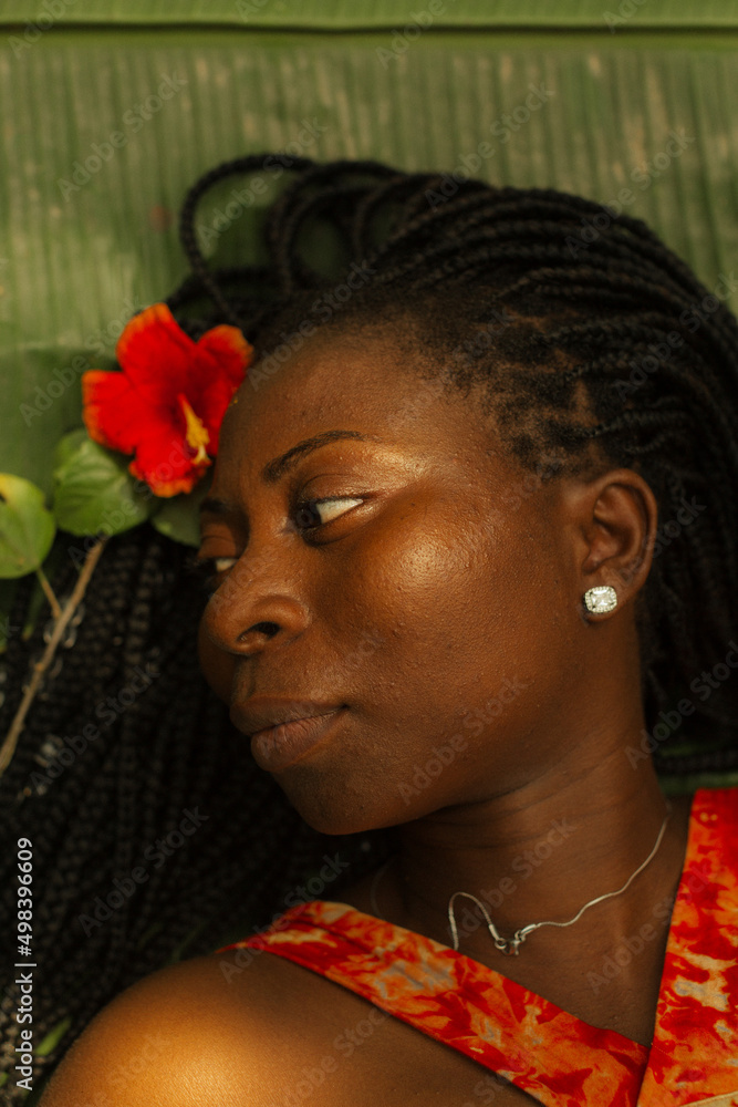 Portrait of a black African female conservationist laying in nature ...