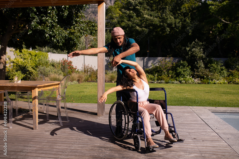 African american disabled woman on a wheelchair dancing with her ...