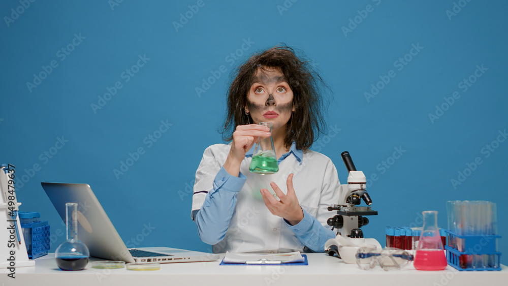 Crazy amusing chemist analyzing lab beaker and acting insane, being ...