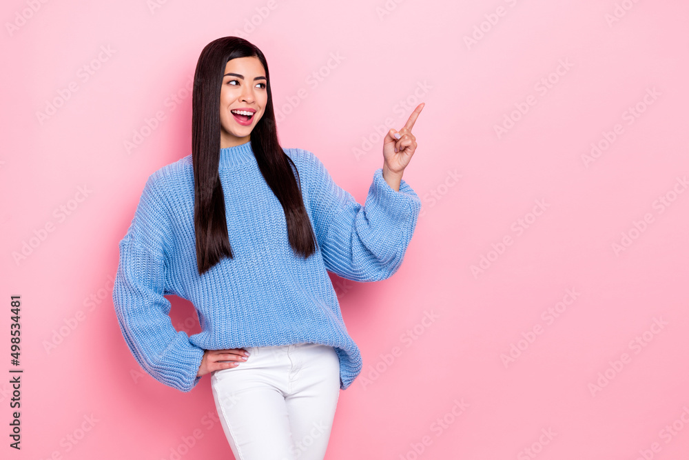 Portrait of attractive cheerful girl demonstrating copy blank space ...