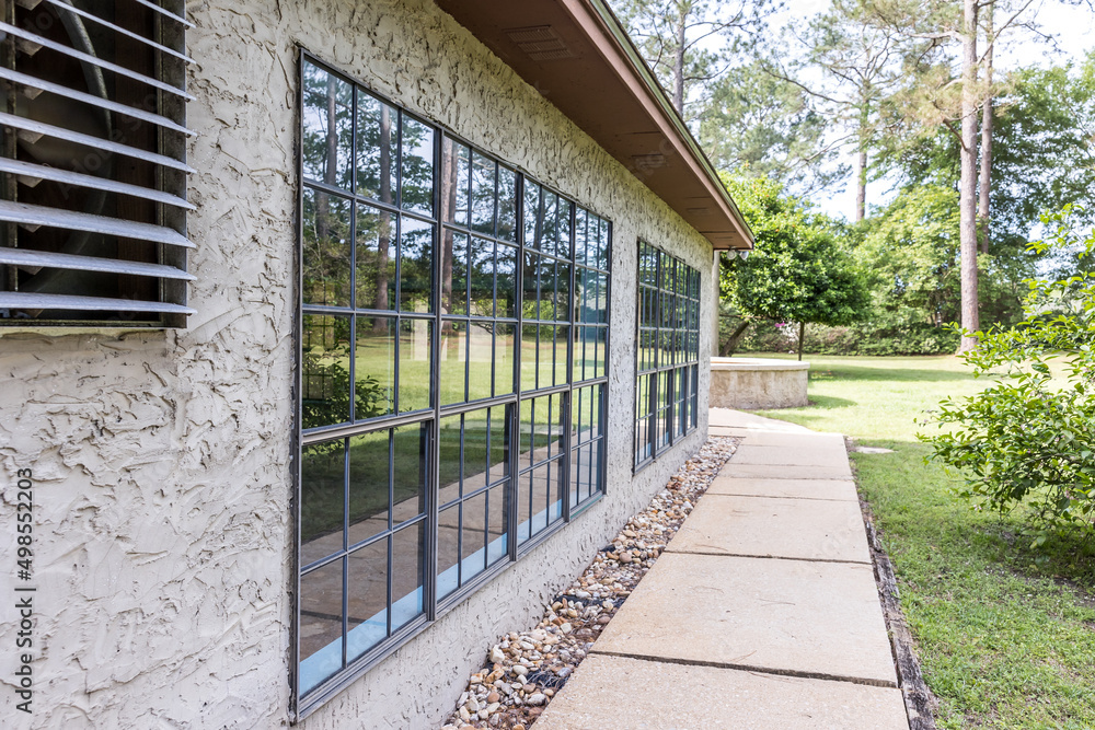 The side view of a brown 1970's ranch style spanish style villa stucco ...